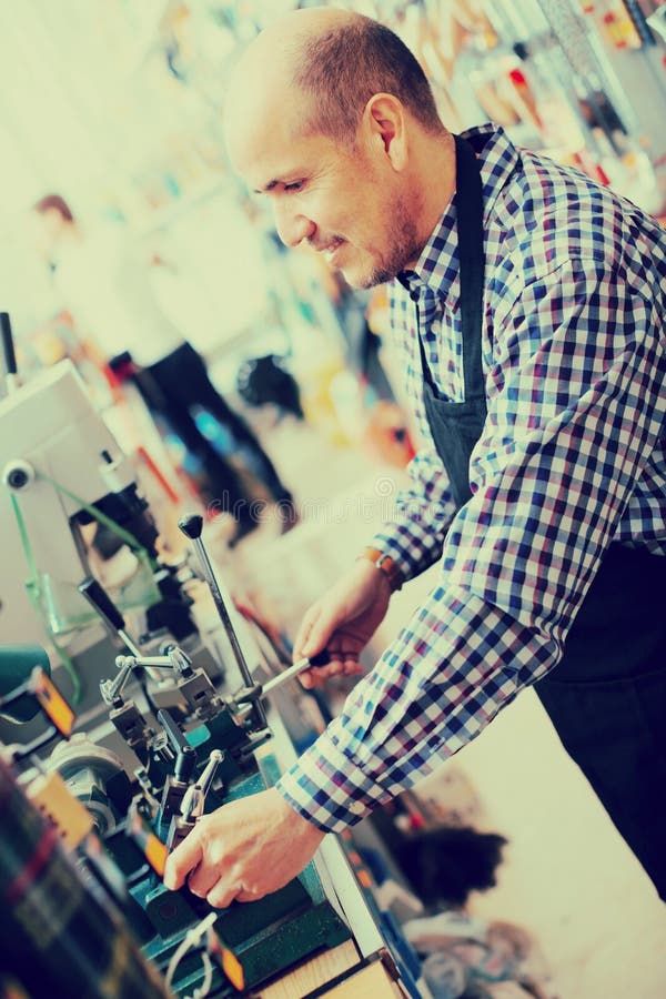 Mature Man Making Duplicates of Keys Stock Photo - Image of locksmith ...