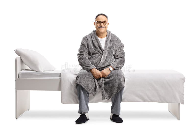 Mature Man in Pajamas and a Robe Sitting on a Bed Stock Image - Image ...