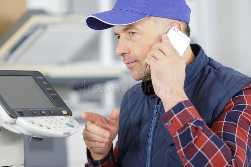 Mature Man on Phone Inspecting Printer Stock Image - Image of ...