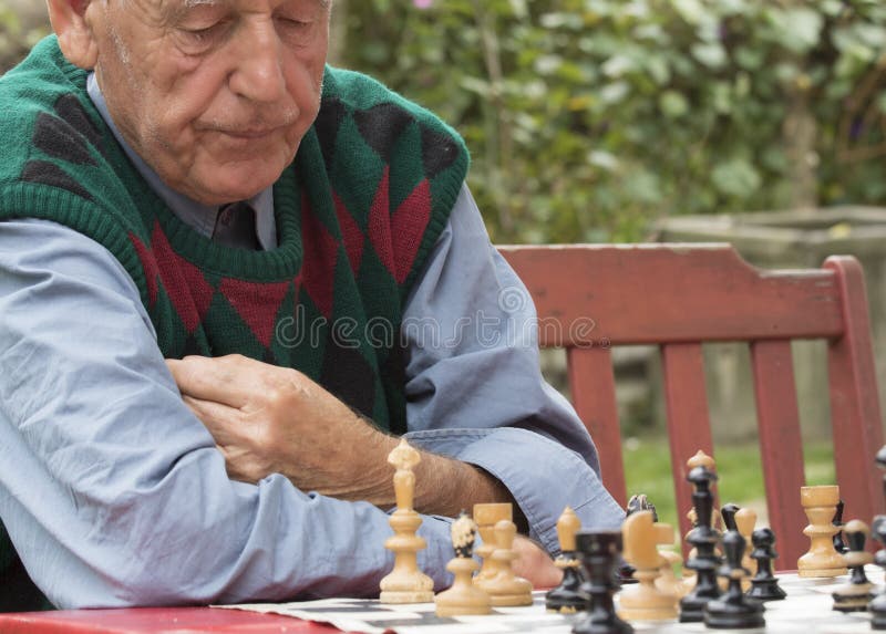 Mature man playing chess stock image. Image of adult - 78602525
