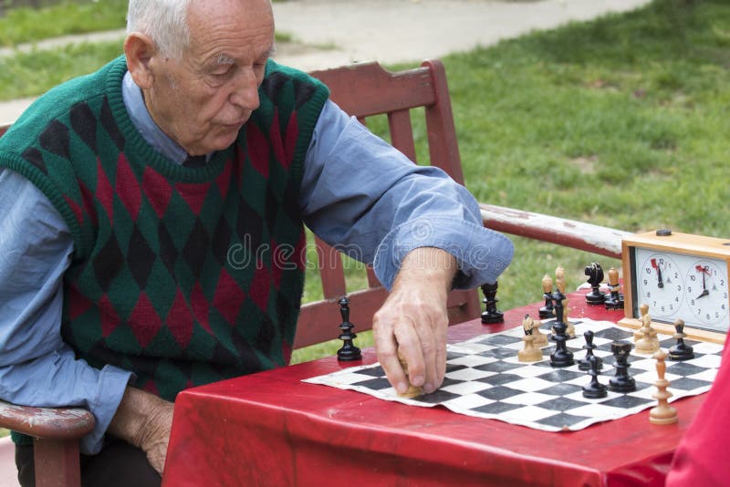 Mature man playing chess stock photo. Image of garden - 78605228