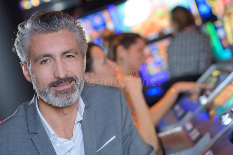 Mature Man Playing Slot Machine Stock Photo - Image of game, alone ...