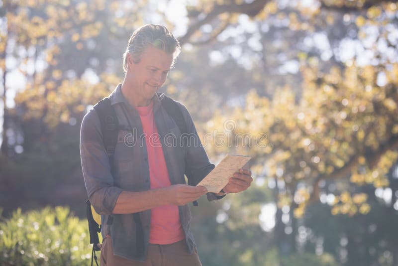 Mature Man Reading Map in Forest Stock Image - Image of holding ...