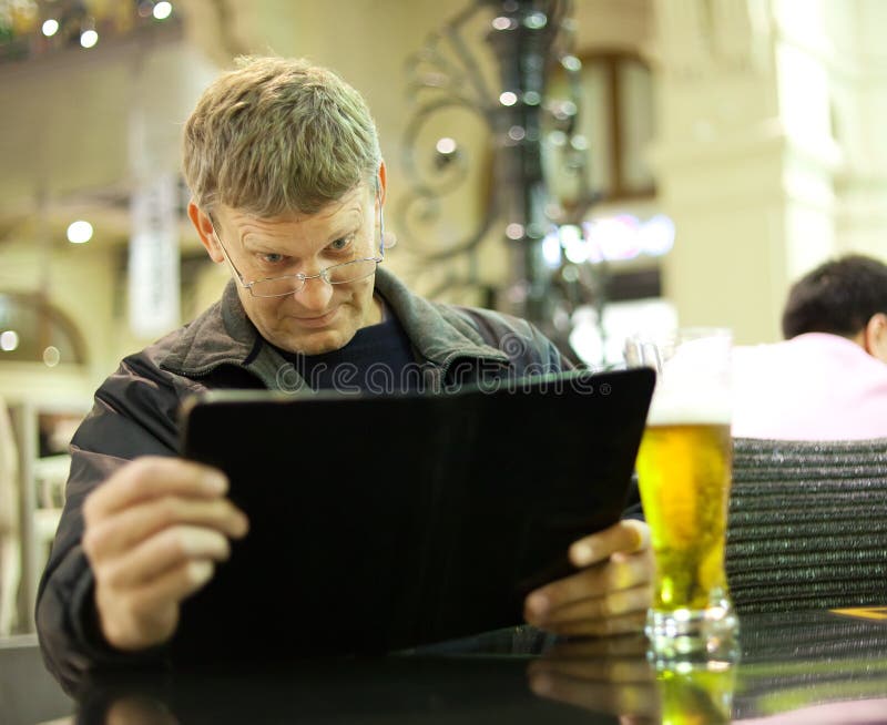 Mature Man Reading Menu Card Stock Photo - Image of cafe, room: 21577486