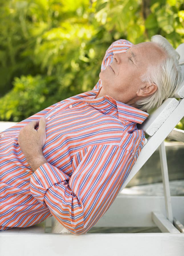 Mature Man Reclining on Lounge Chair Stock Image - Image of caucasian ...