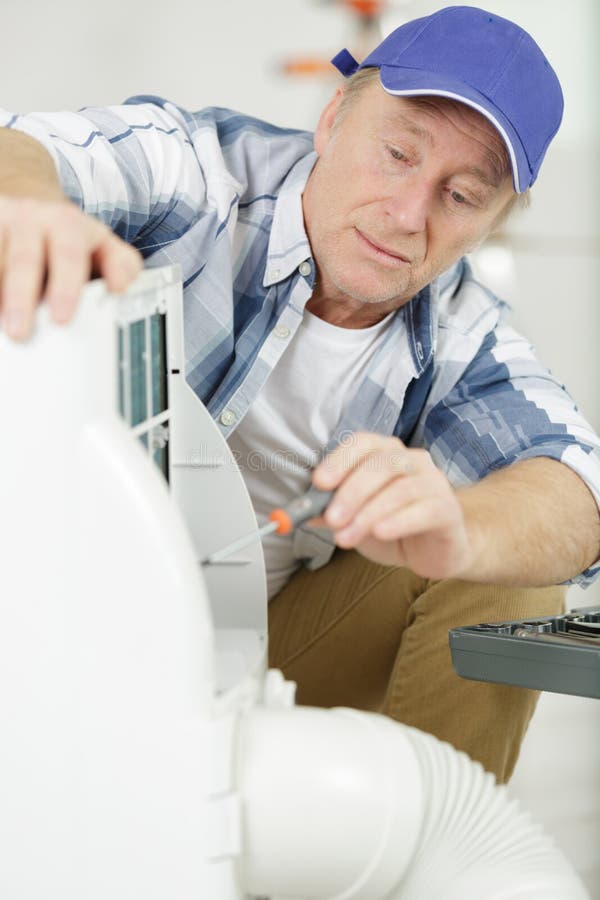 Mature Man Repairing Air Conditioning Unit Stock Image - Image of ...