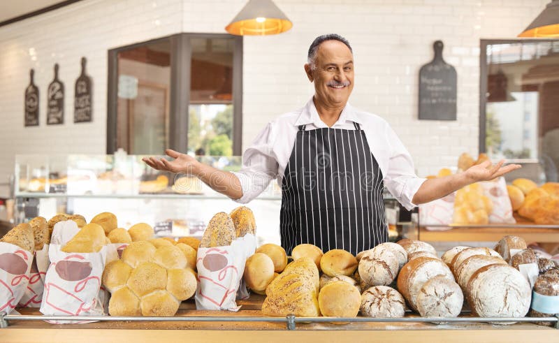 Mature man selling bread stock photo. Image of bakery - 338529282
