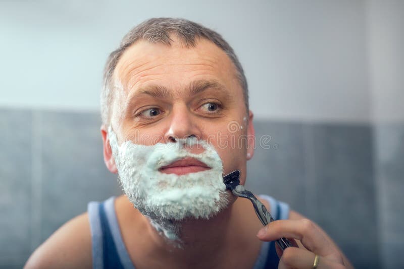 Mature Man Shaving in Front of Mirror Stock Image - Image of aged ...