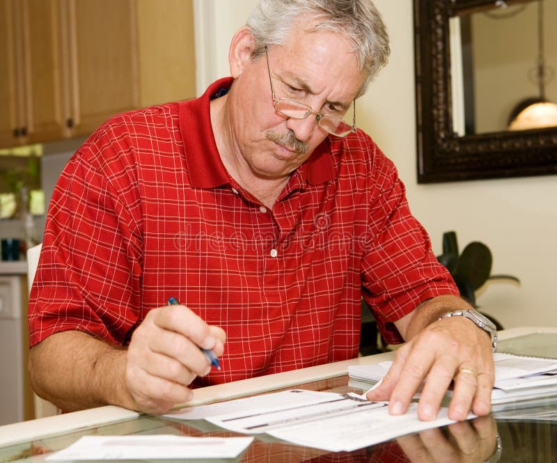 Mature Man Signing Papers stock photo. Image of fifty - 4901658