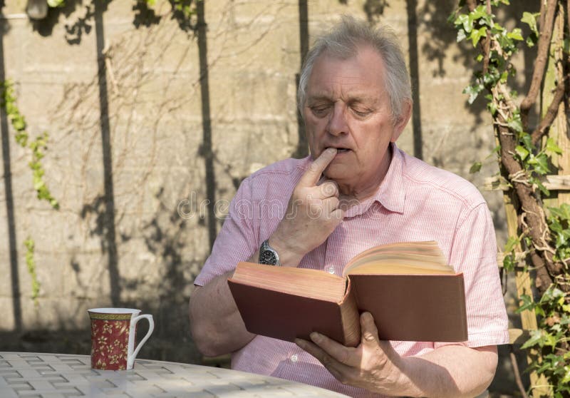 Mature Man Sitting Outside Reading a Book Stock Photo - Image of ...