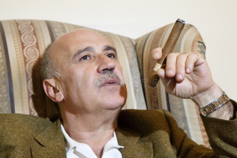 Mature Man Smoking Cigar while Relaxing on Armchair Stock Image - Image ...