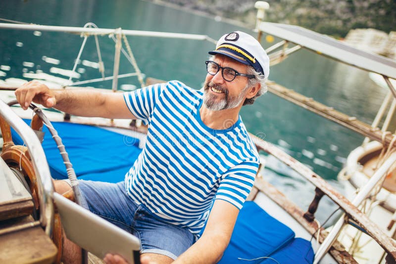 Man Standing on the Deck of His Boat and Using Digital Tablet on a ...