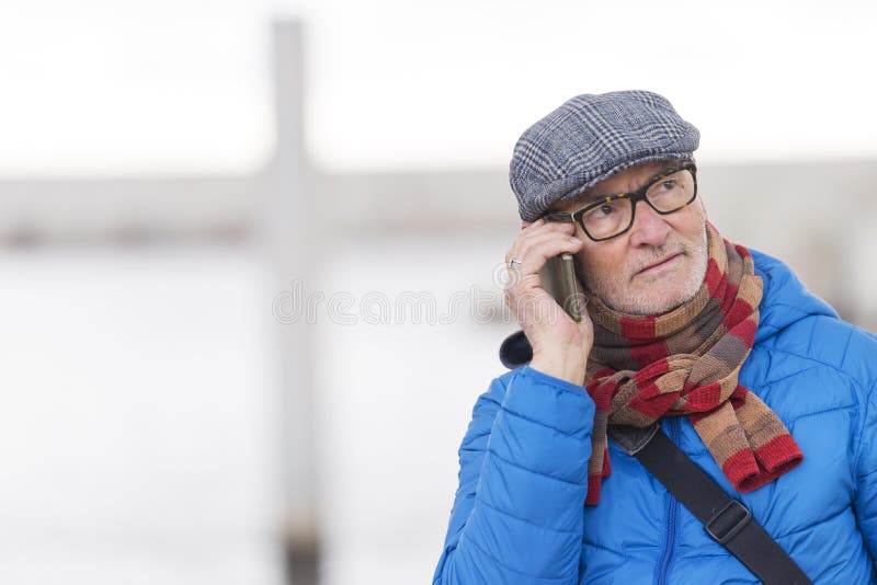 Senior Man Talking on Mobile Phone in the Street Stock Photo - Image of ...