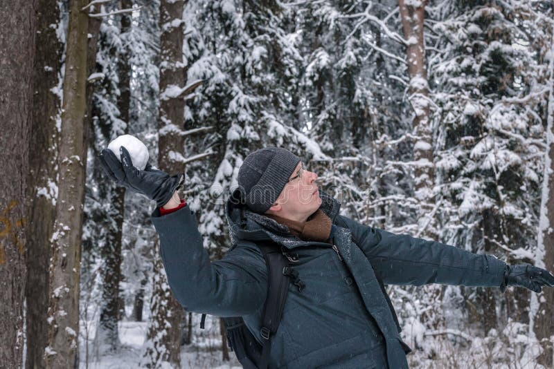 Mature Man Throwing Snowball in Forest in Winter. Side View, Profile ...