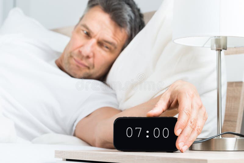 Mature Man Turning Off Clock Stock Photo - Image of people, rest: 55850258