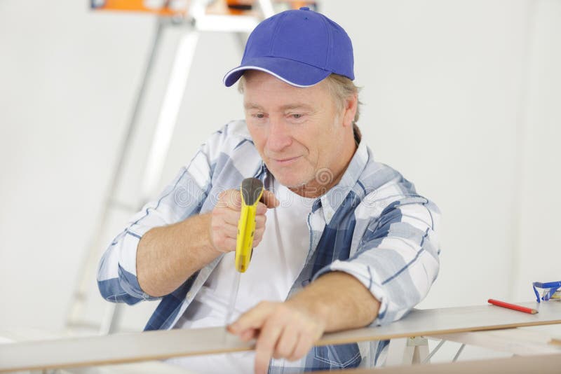 Mature man using hand saw stock image. Image of amateur - 173081095