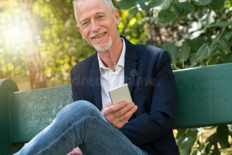 Mature Man Using His Mobile Phone, Light Effect Stock Image - Image of ...