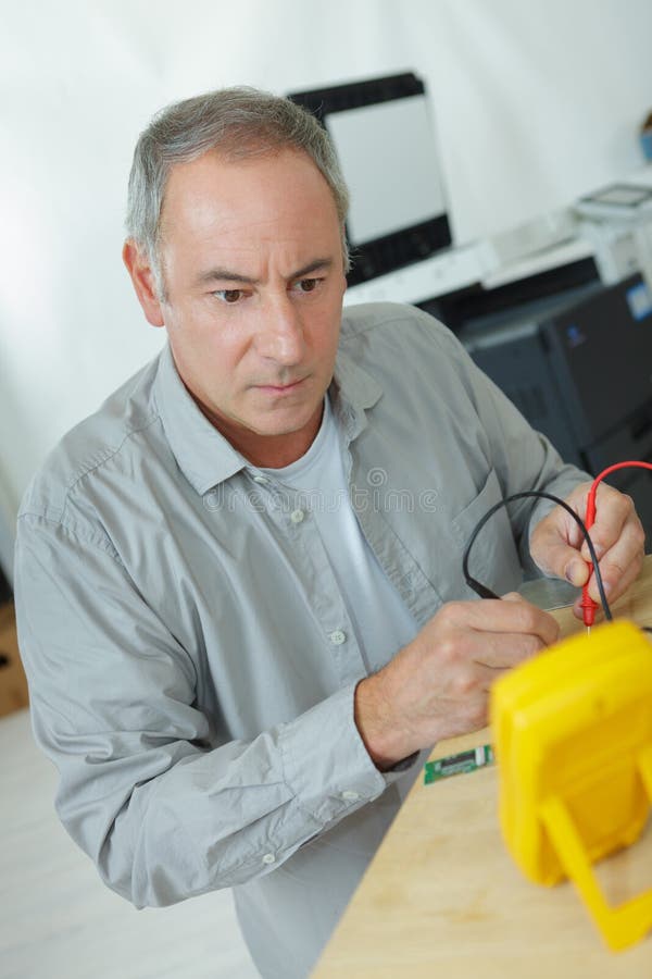Mature Man Using Multimeter Stock Image - Image of measurement, hand ...