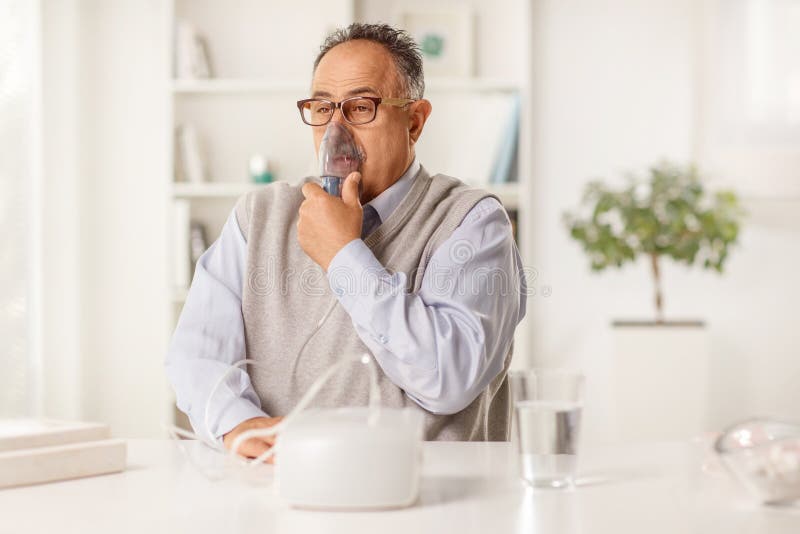 Mature Man Using a Nebulizer Stock Photo - Image of inhaling, person ...