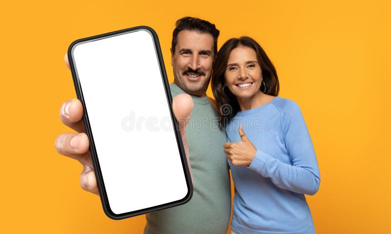 Mature Man And Woman Holding Up A Cell Phone Stock Image Image Of
