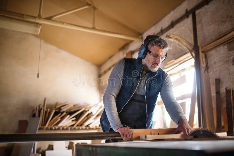 A Man Worker in the Carpentry Workshop, Working with Wood. Stock Photo ...