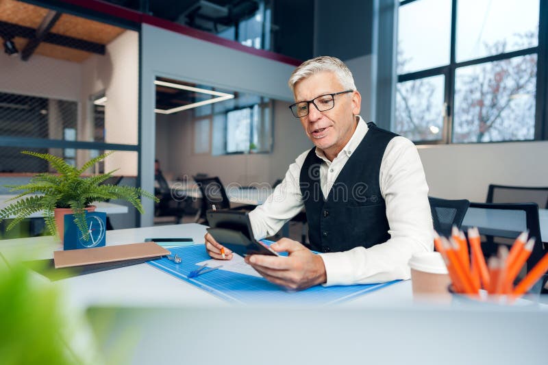 Mature Man Working on Architectural Project in Office Stock Photo ...