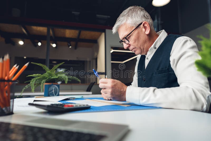 Mature Man Working on Architectural Project in Office Stock Photo ...