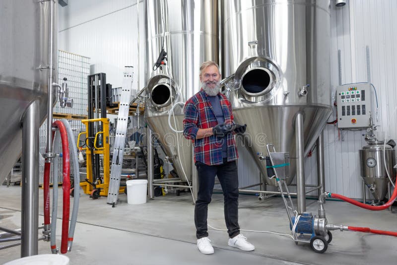Mature Man Working at the Factory and Looking Contented Stock Photo ...