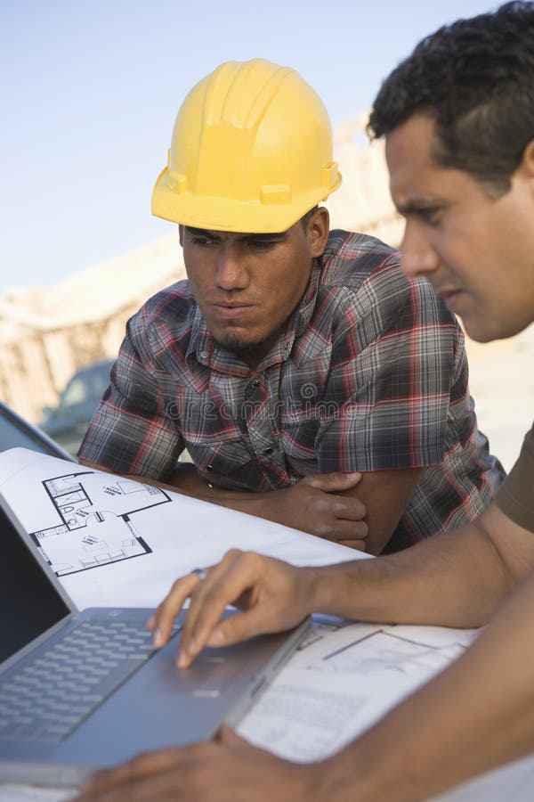 Mature Man Working on Laptop with Co-Worker Stock Image - Image of ...