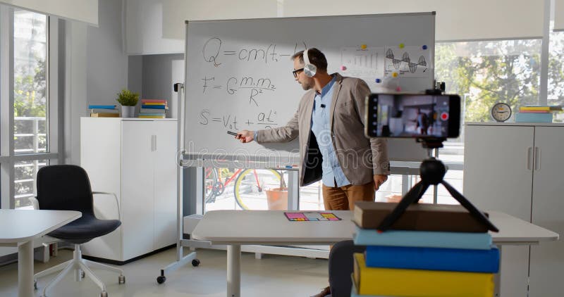 Mature Math Teacher Recording Tutorial Video for Students on Smartphone ...