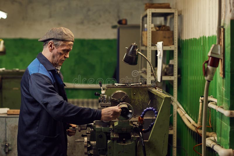 Mature Mechanic Working at Lathe Stock Image - Image of industry ...