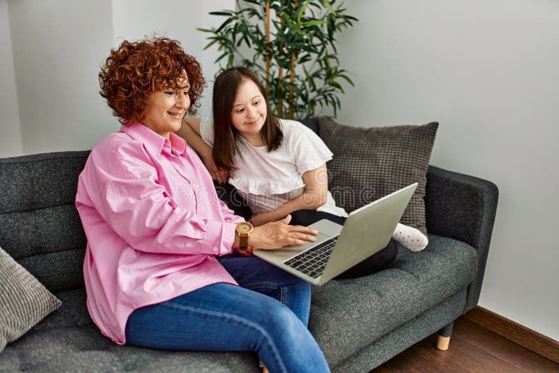 Mature Mother and Down Syndrome Daughter at Home Using Computer Laptop ...