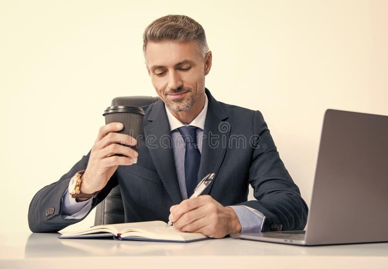 Mature Office Worker Writing at the Table in Business Office and ...