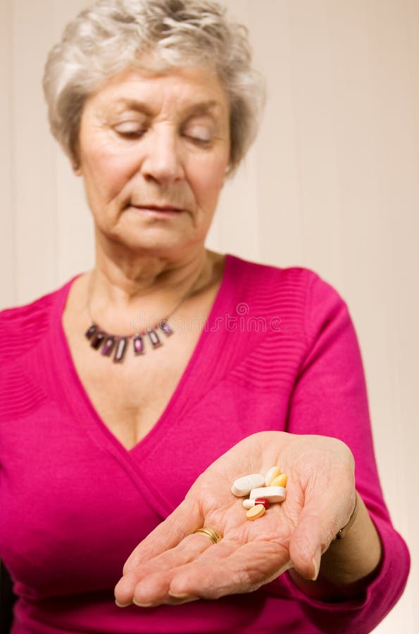 Mature Older Lady Holding Tablets or Pills Stock Photo - Image of ...