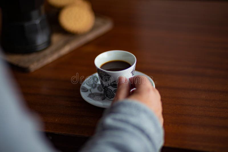 Mature Person S Hand Reaching To a Cup of Coffee on the Table Stock ...