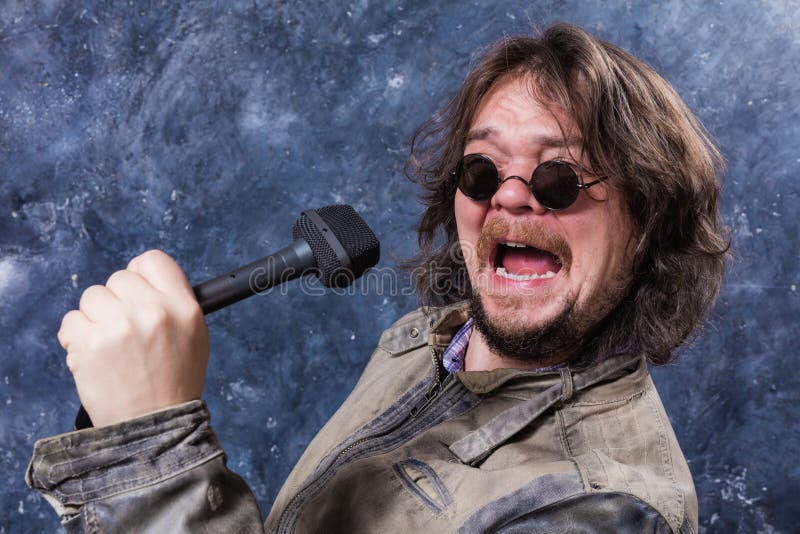 Mature Rocker with Microphone Emotional Studio Portrait. Stock Photo ...