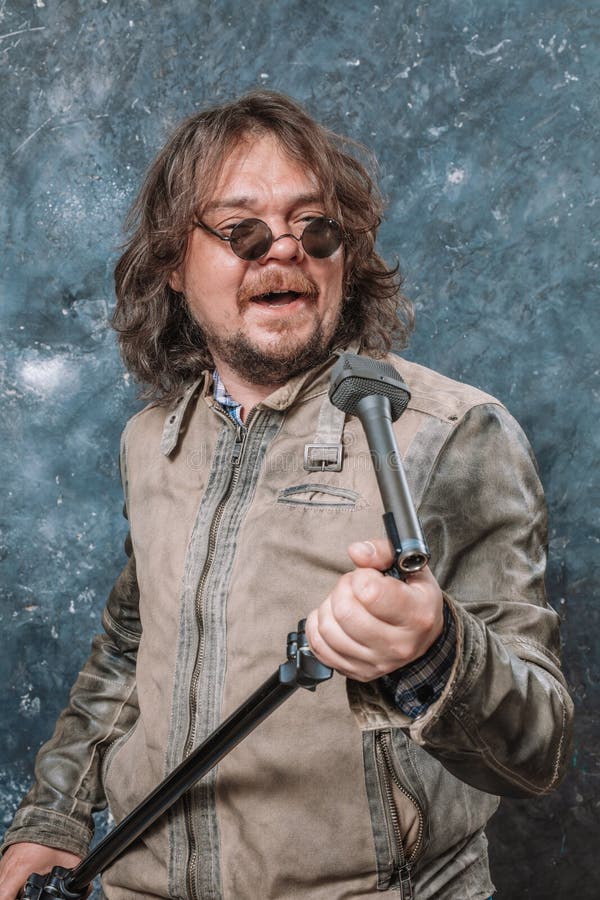 Mature Rocker with Microphone Emotional Studio Portrait. Stock Photo ...