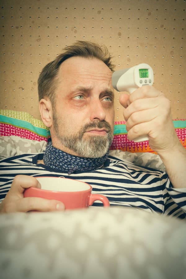 Sick Man with Flu and Cold Checking His Teplerature with Thermometer ...