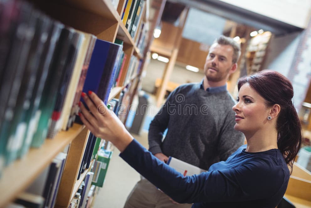 Mature Student Removing Book from Shelf Stock Image - Image of ...