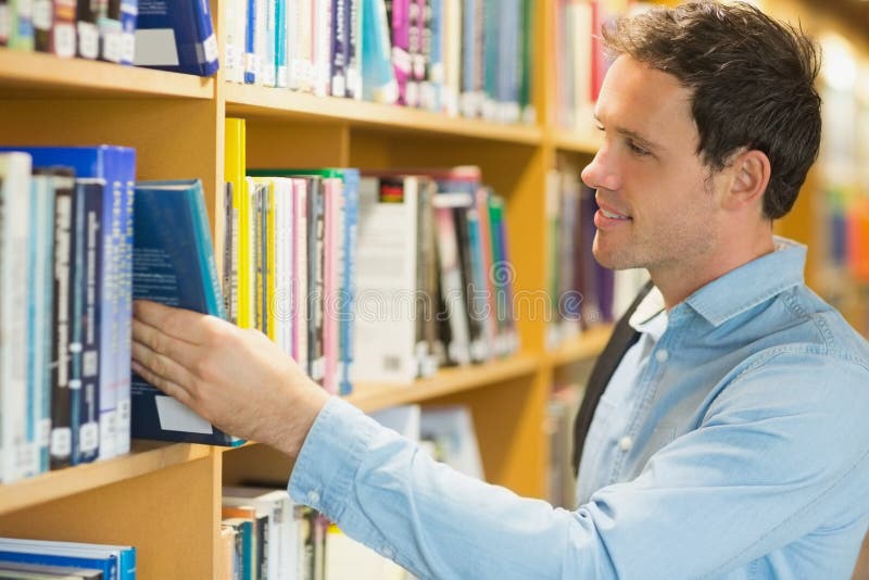 Mature Student Selecting Book from Shelf in Library Stock Photo - Image ...