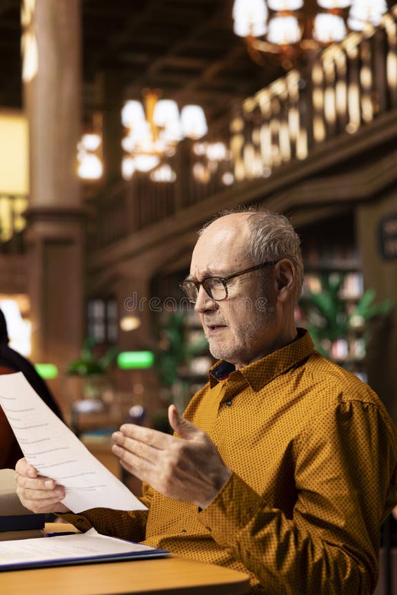Mature Student in a Study Room Surrounded by Books and Paperwork Stock ...