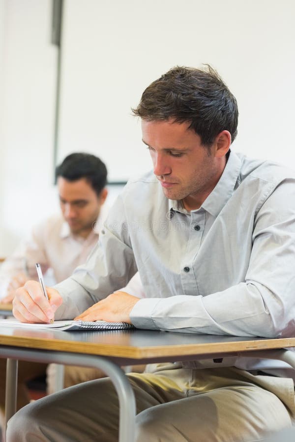 Mature Students Taking Notes in Classroom Stock Photo - Image of ...