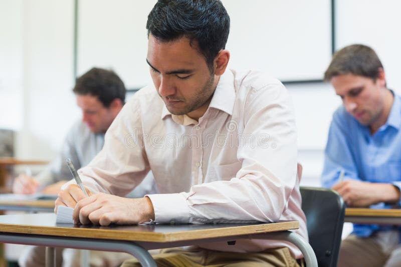 Mature Students Taking Notes in Classroom Stock Image - Image of people ...
