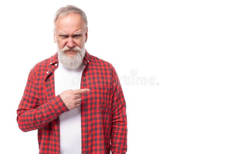 Mature Sullen Gray-haired Man with a Beard Points His Finger at the ... Mature Sullen Gray-haired Man with a Beard Points His Finger at the ...