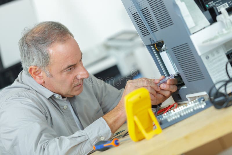 Mature Technician Checking Voltage Printer Stock Image - Image of ...