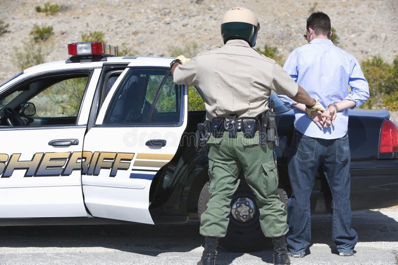 Traffic Cop Arresting Man stock photo. Image of people - 29651266