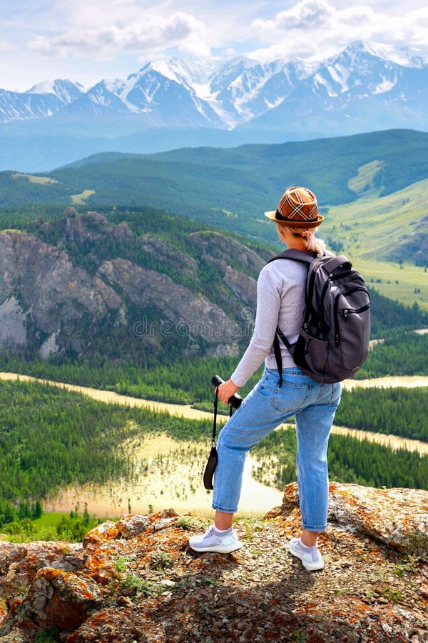 Mature Woman with a Backpack on Her Back Stands on a Mountain Stock ...
