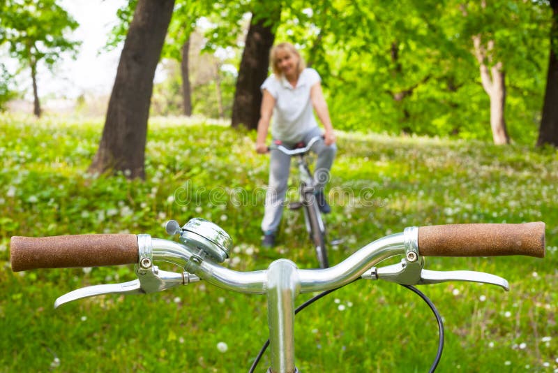 Mature Woman Biking Outside Stock Photo - Image of outdoor, outdoors ...