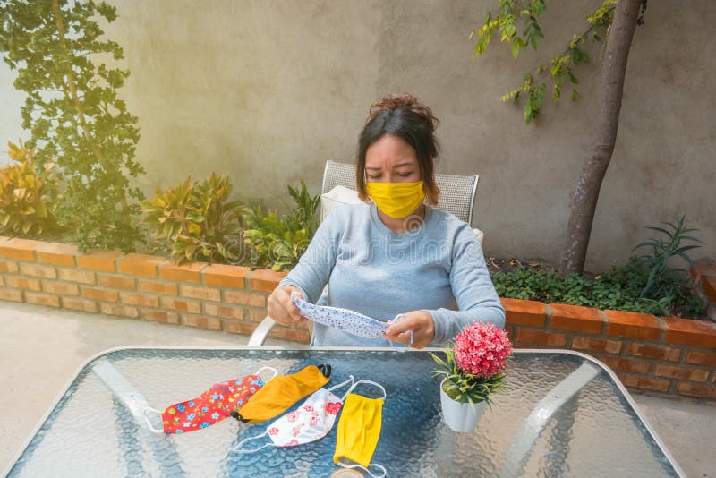Mature Woman Checking Out Self-made Face Masks Stock Image - Image of ...