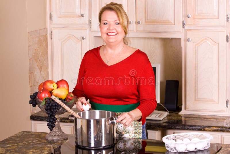 Mature Woman Cooking Pasta. Stock Photo - Image of american, green ...